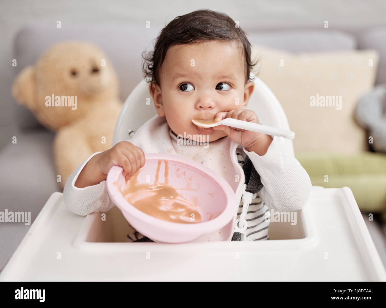 Baby eating alone hi-res stock photography and images - Alamy