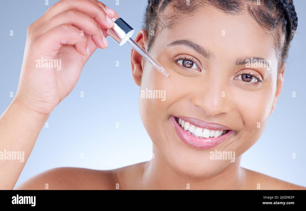 Create your glow. Studio portrait of an attractive young woman applying ...