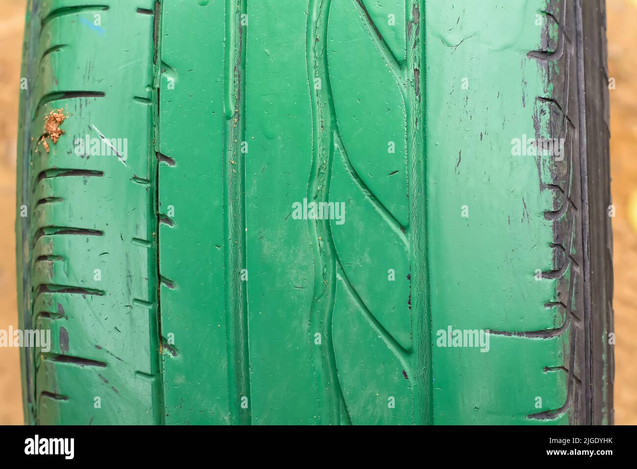 A closeup of used car tires texture painted in green color Stock Photo ...