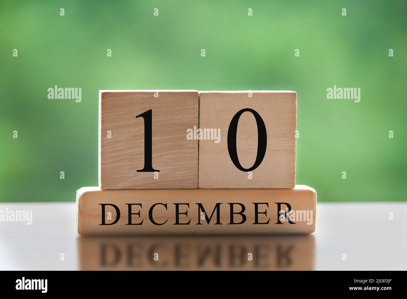 December 10 text on wooden blocks with blurred nature background. Copy ...