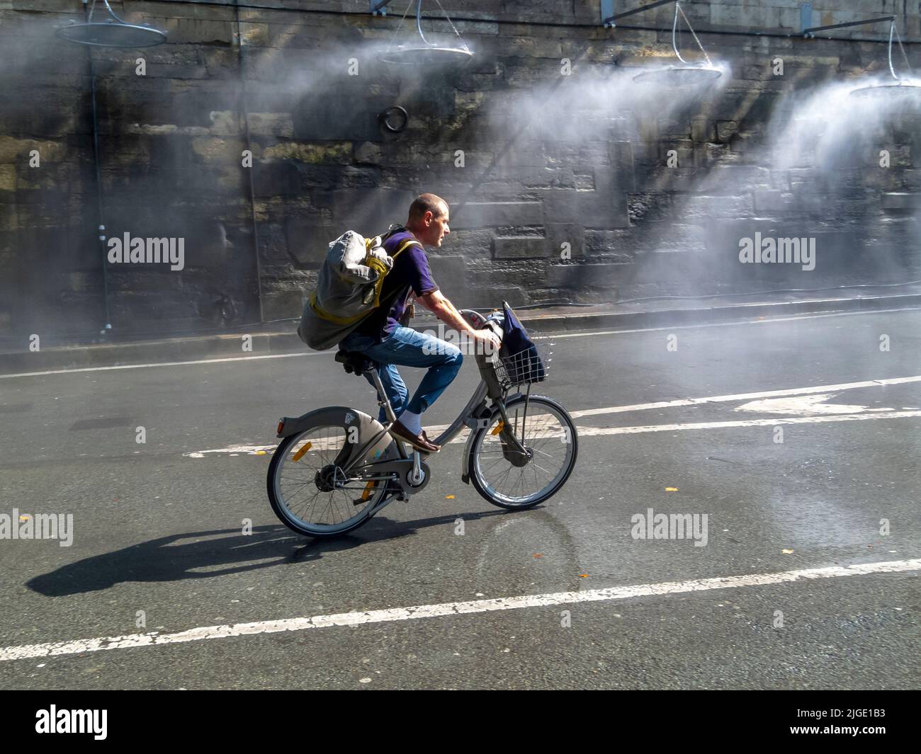 Paris, France, Man Cycling in Water Spray at Paris Plages Event, Heat ...