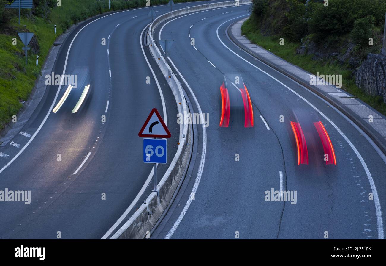 Danger sign on the road, car lights at night Stock Photo - Alamy
