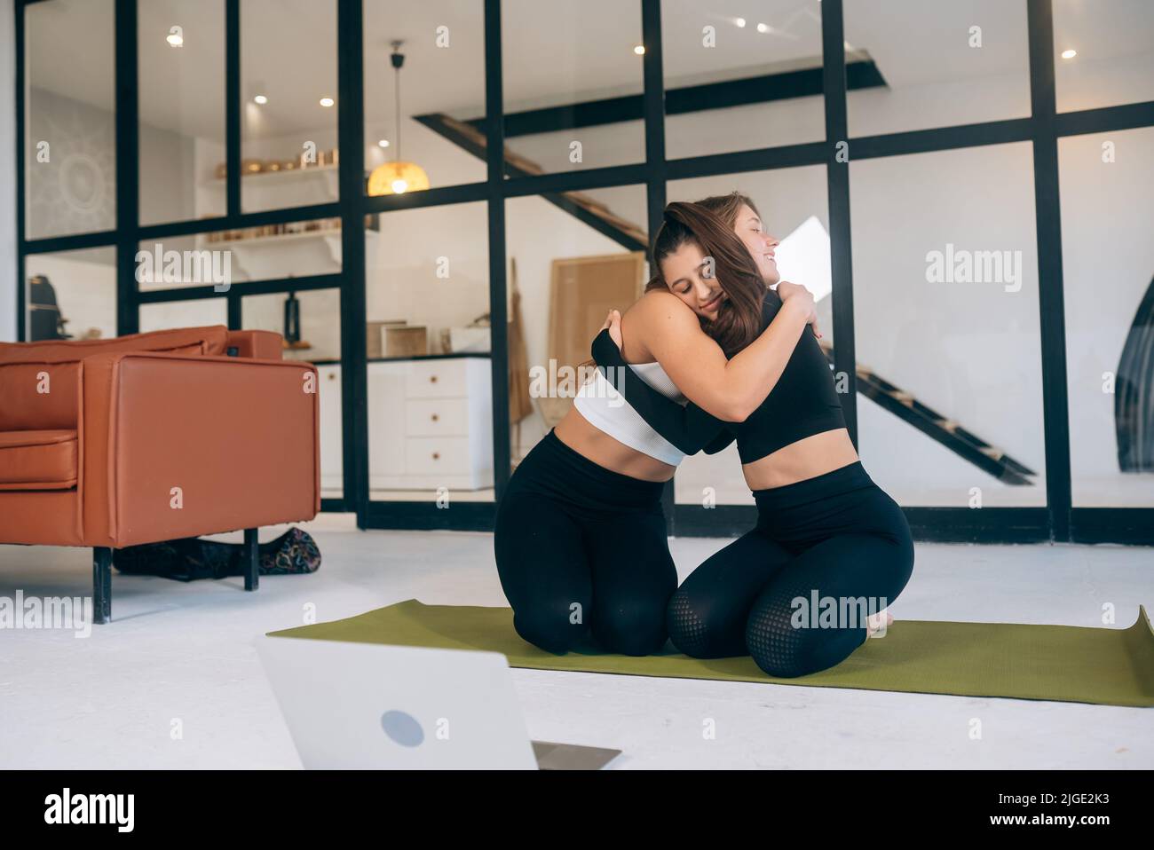 Two girlfriends hug each other after yoga Stock Photo - Alamy