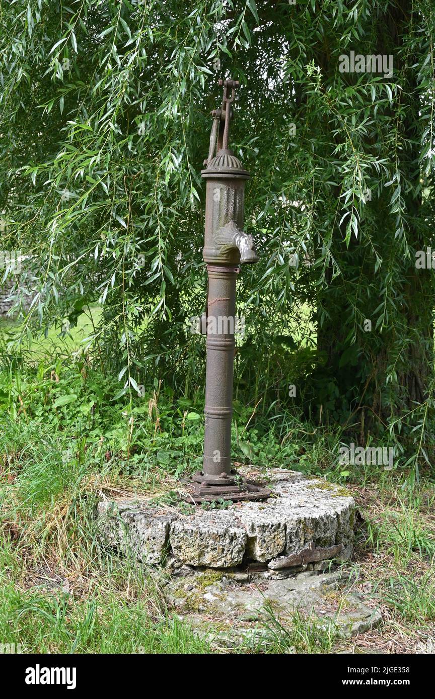 A disused water pump stands on the edge of rthe village green and The ...