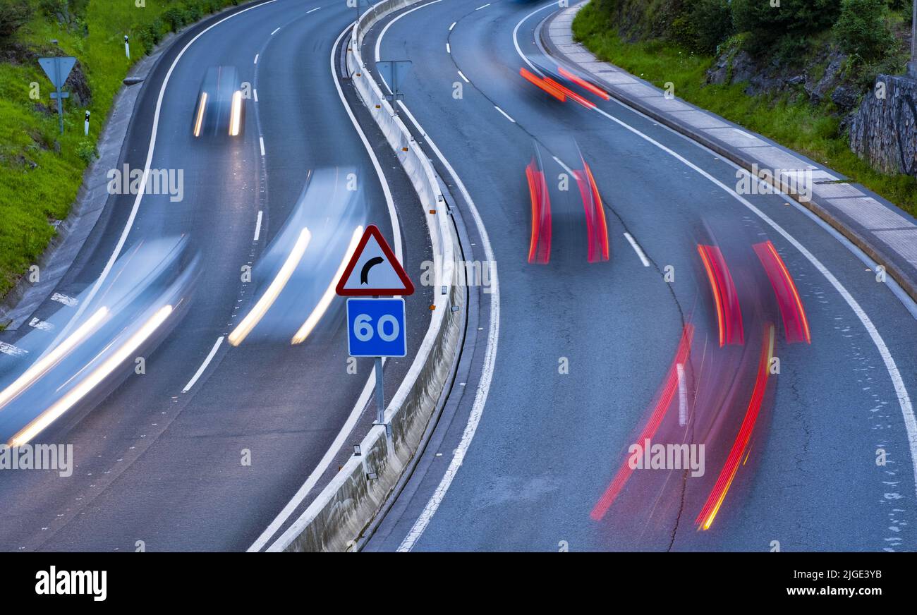 Danger sign on the road, car lights at night Stock Photo - Alamy