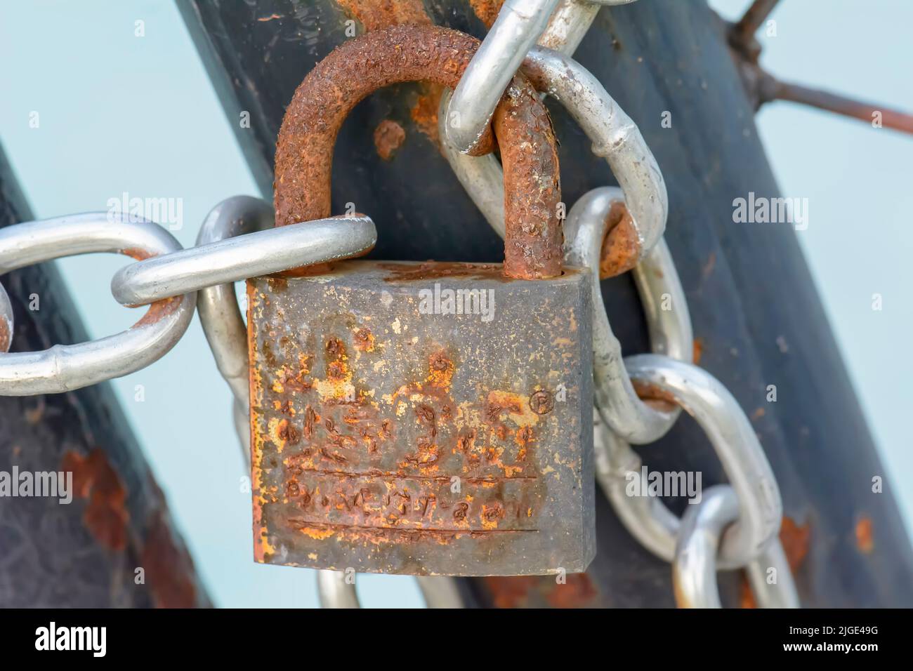 A lock and chain on a metal fence Stock Photo - Alamy