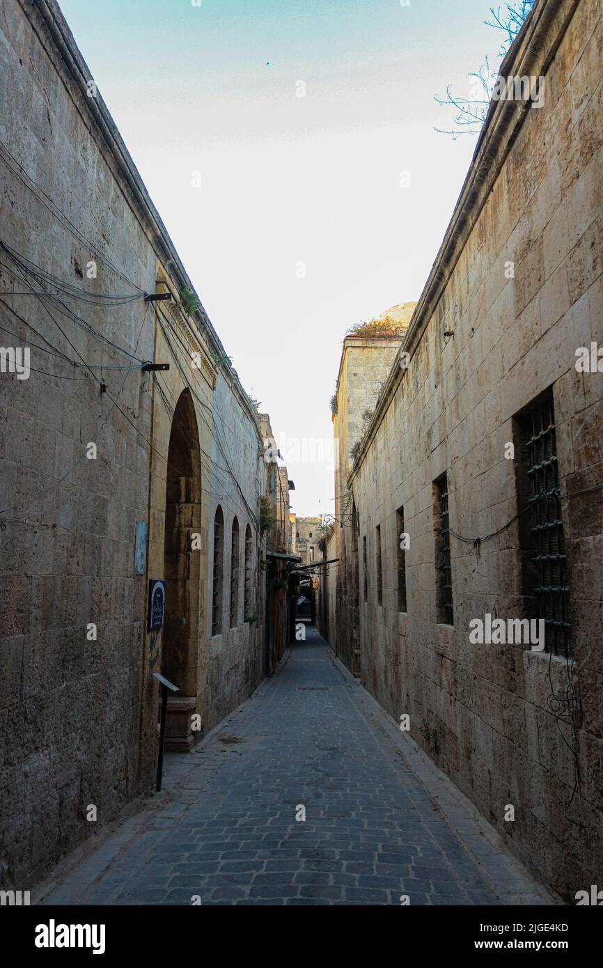 A vertical shot of a narrow walkway between old brick buildings in ...