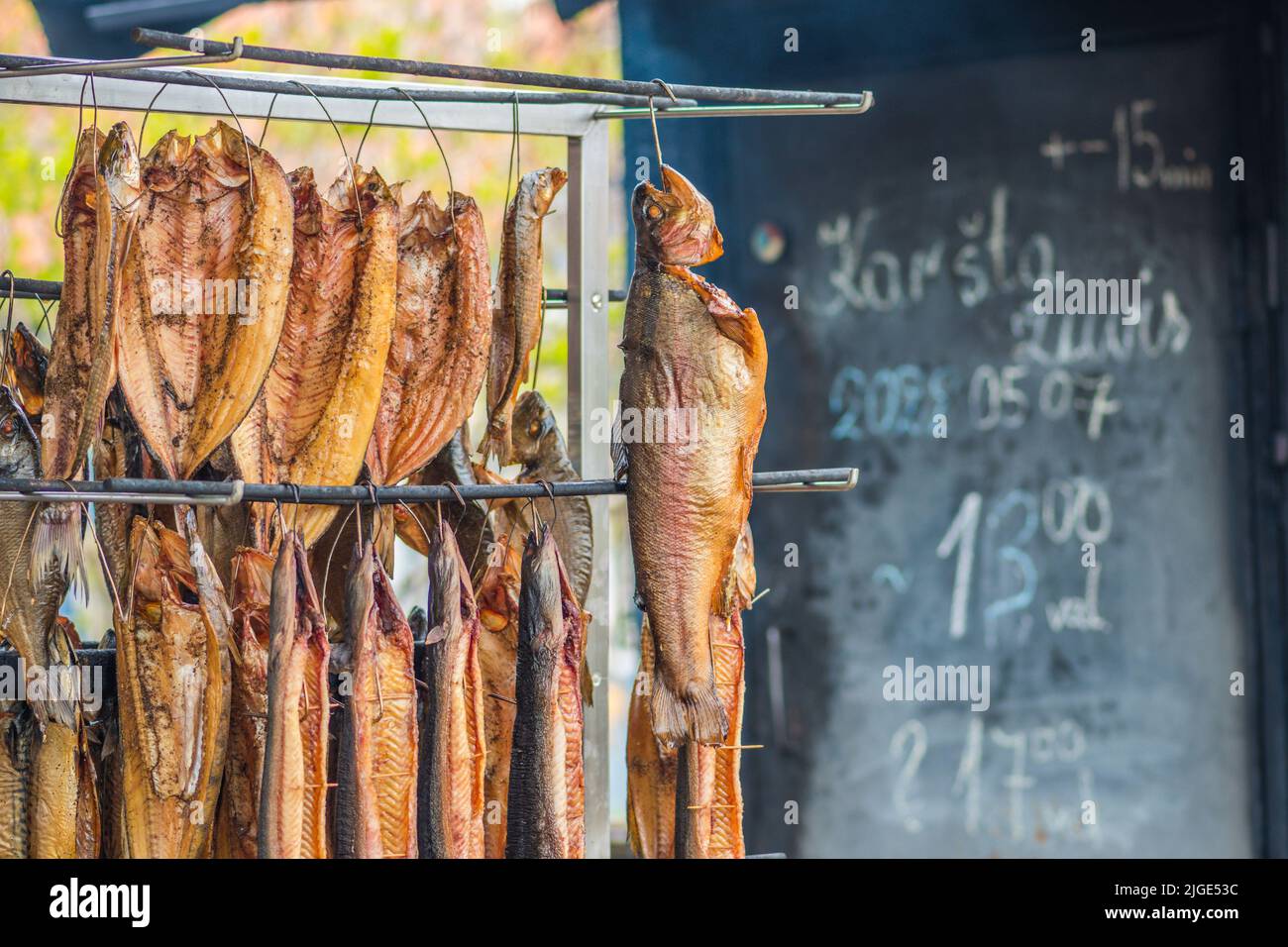 Hanging smoke-dried various fish in a fish market just smoked with ...