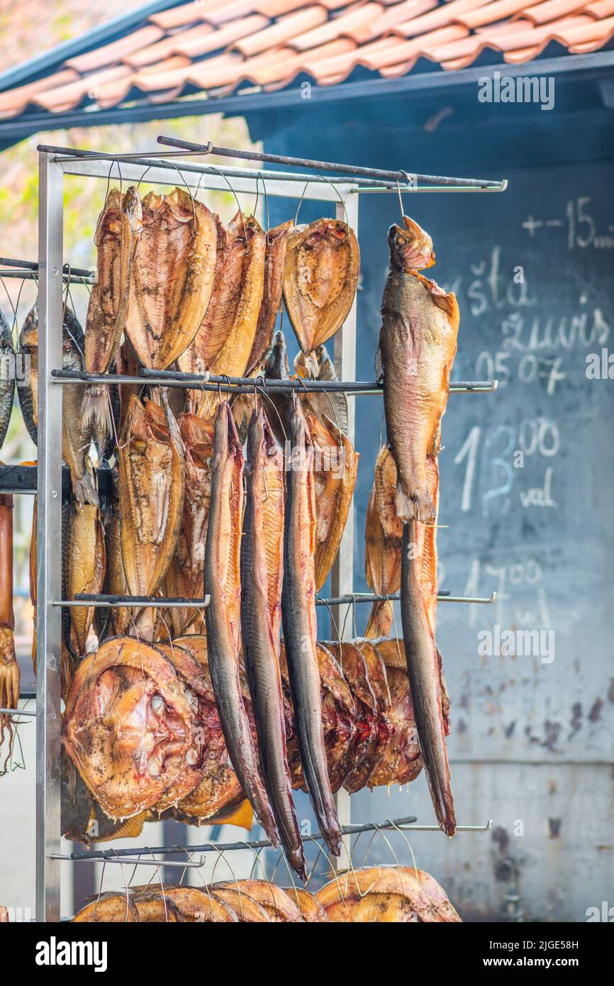 Hanging smoke-dried various fish in a fish market just smoked with ...