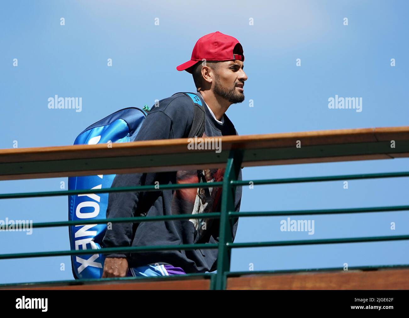 Nick Kyrgios walks across the players bridge on day fourteen of the ...