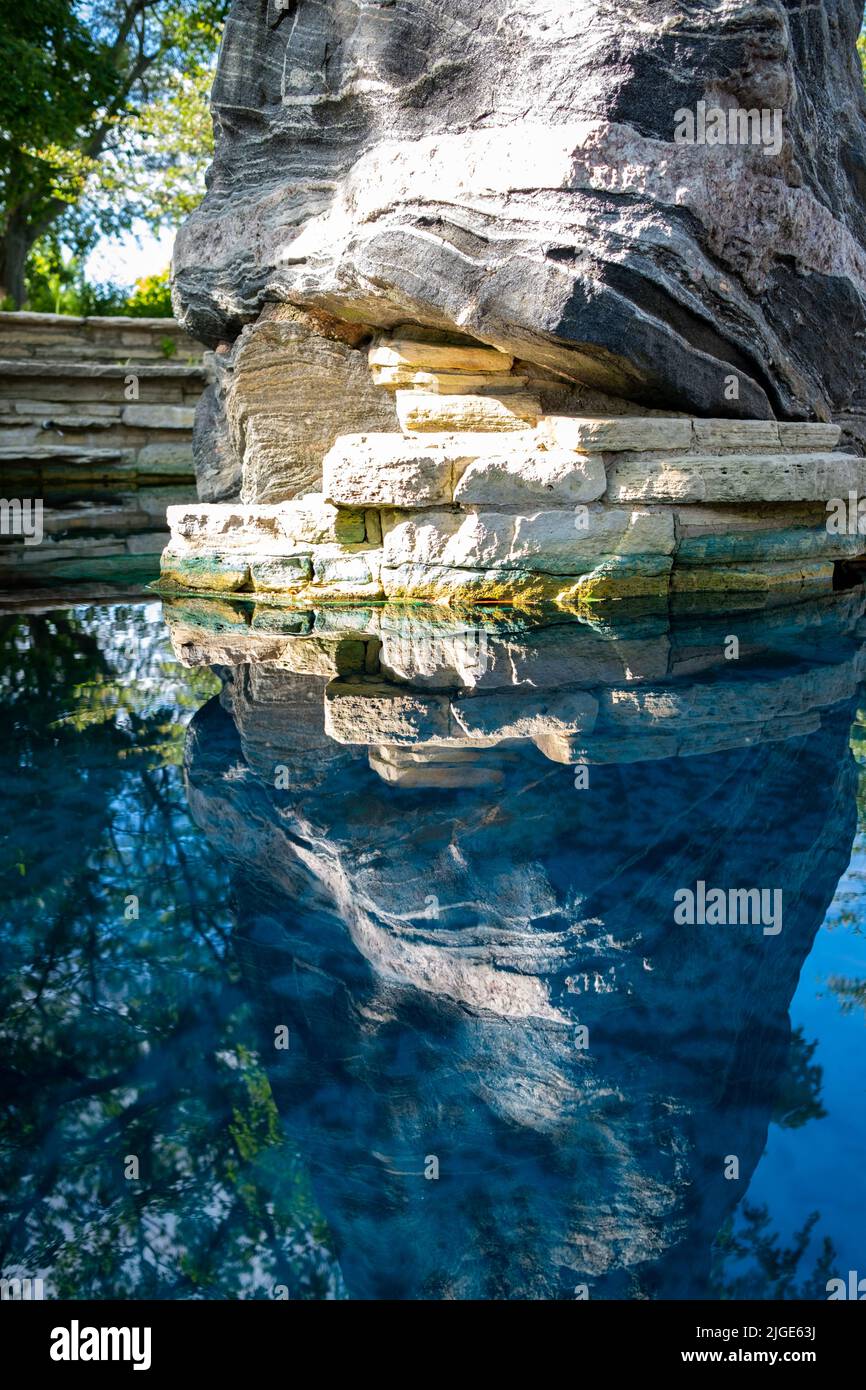 A beautiful landscape of a stone wall with the reflection on the clear ...