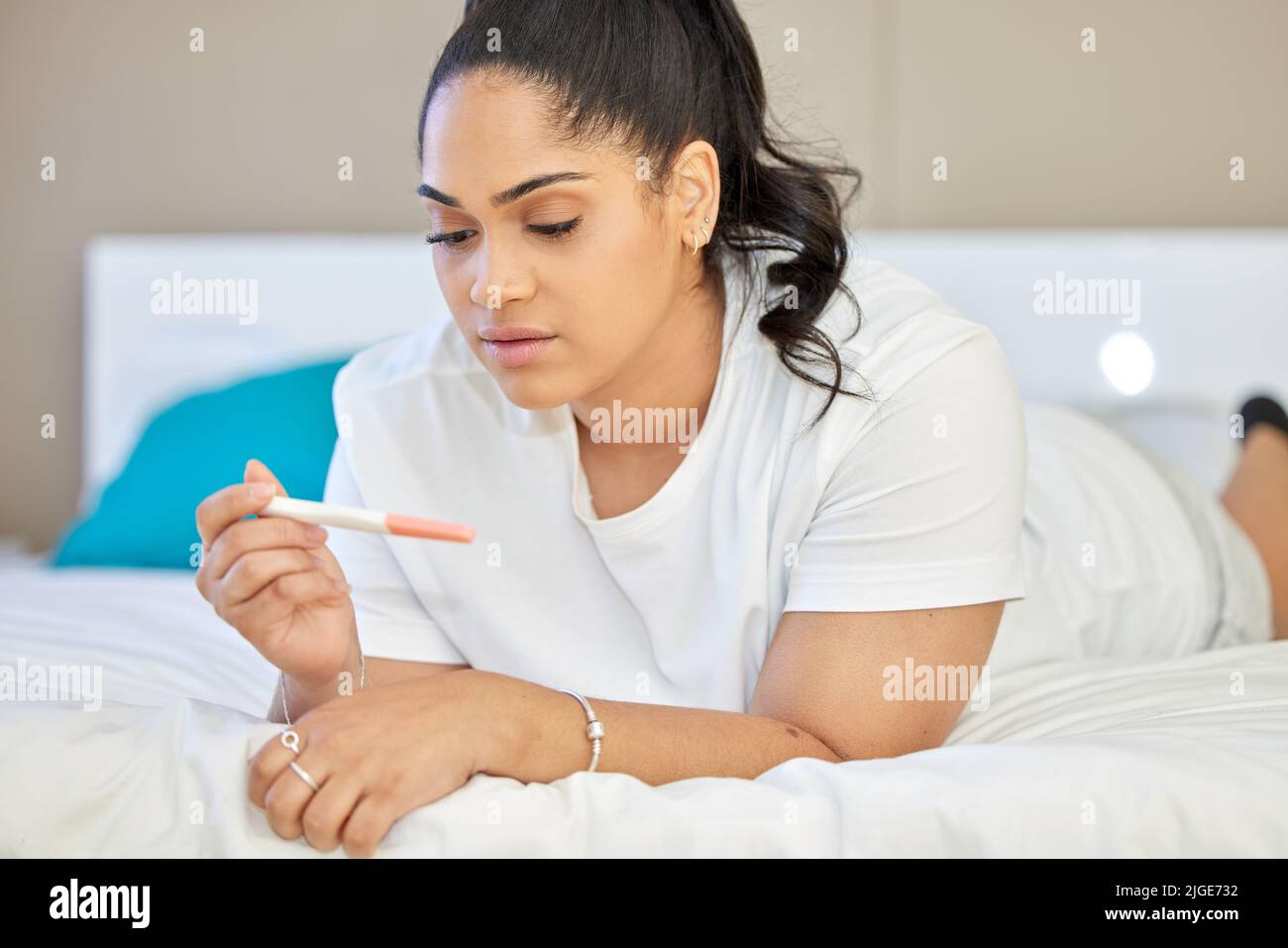 Am I finally going to be a mom or not. a young woman taking a pregnancy ...