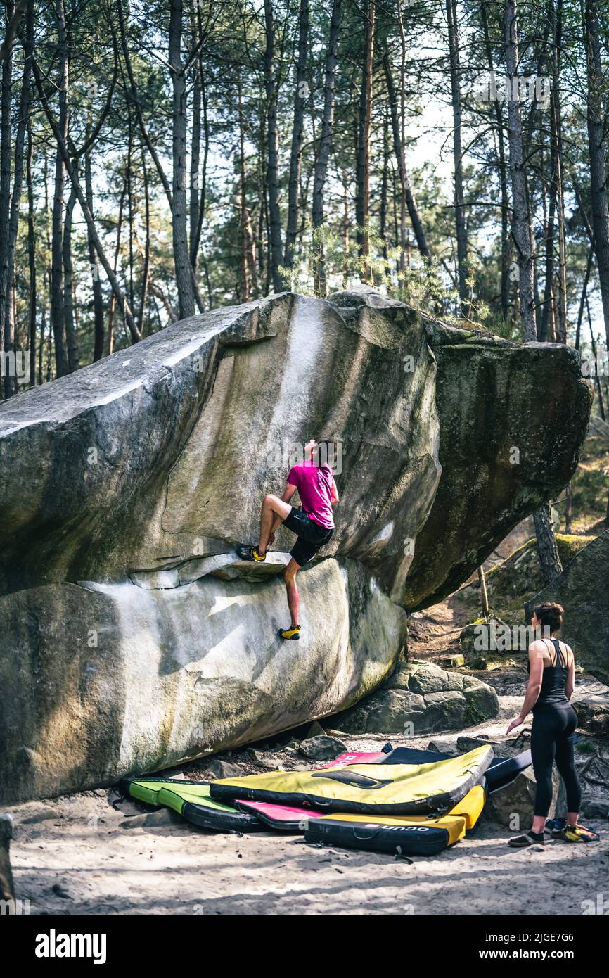 Athletic young man is jumping for top hold in famous and hard dyno ...