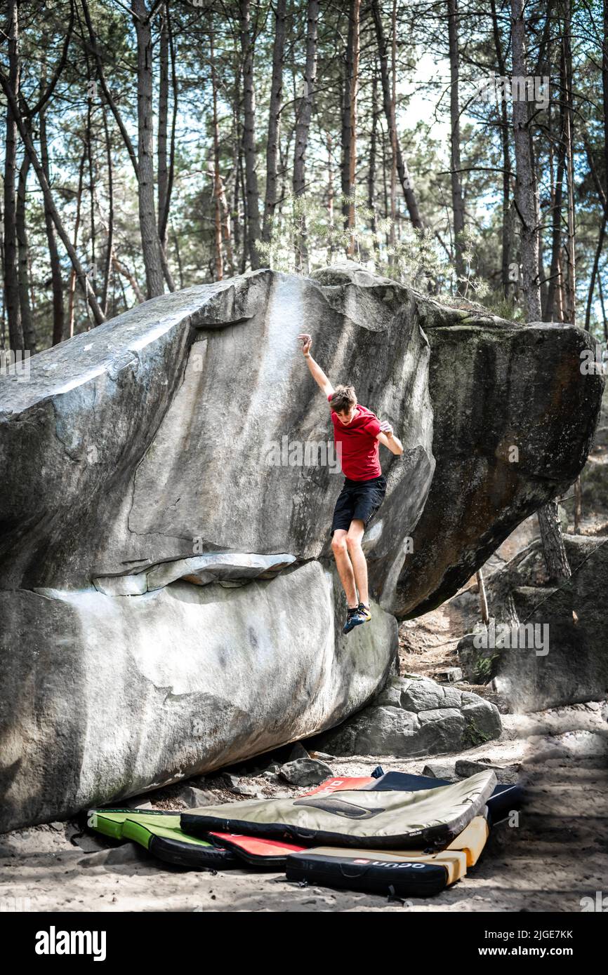 Athletic young man is jumping for top hold in famous and hard dyno ...