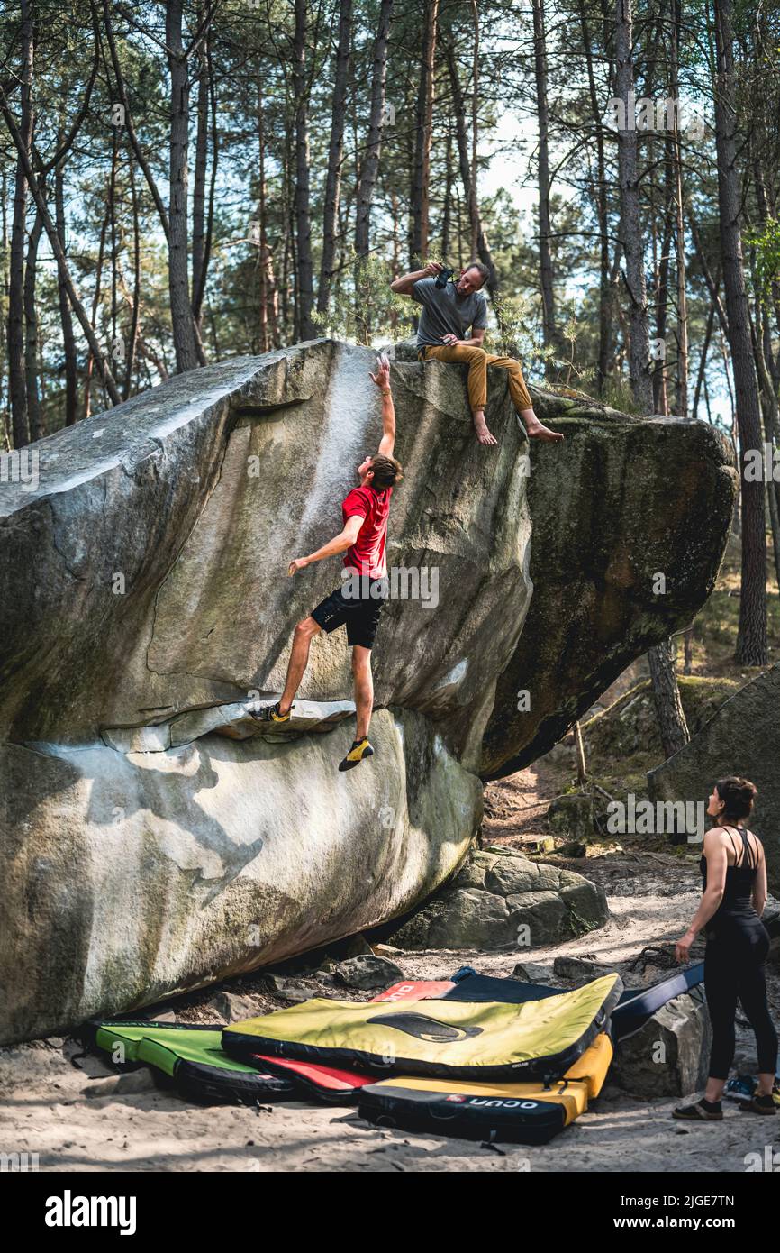 Athletic young man is jumping for top hold in famous and hard dyno ...