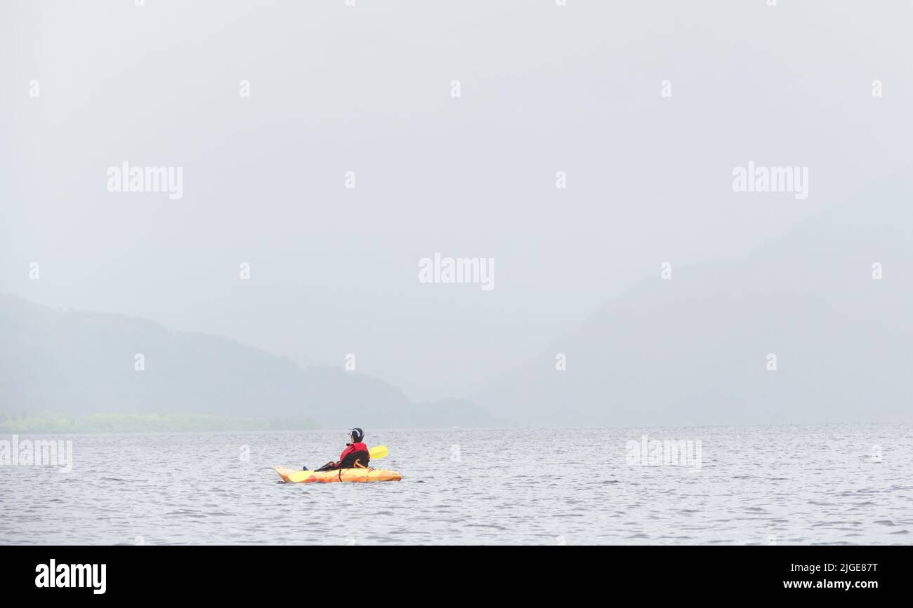 Yellow kayak on open water at Loch Lomond Stock Photo - Alamy