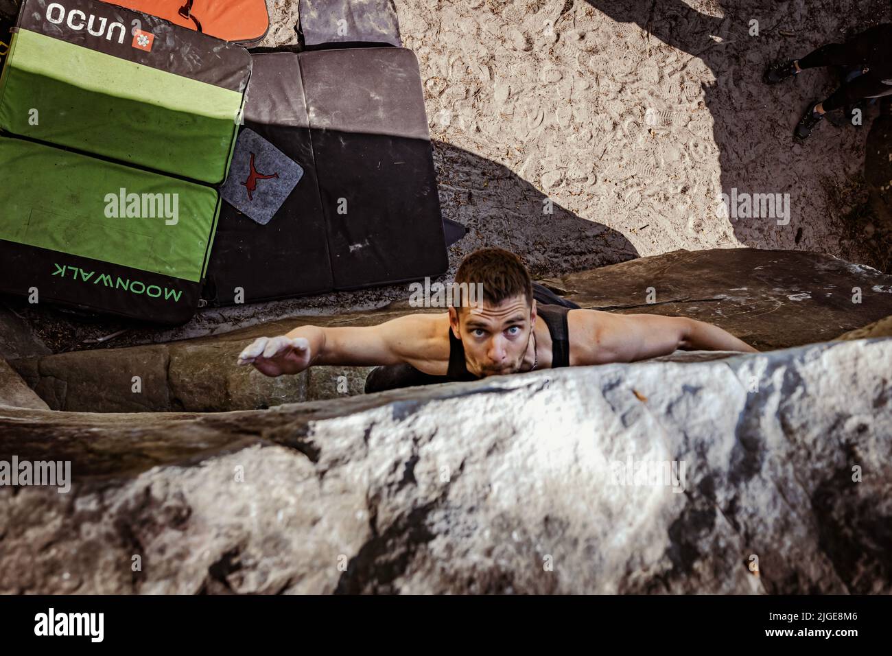 Climber jumps to top hold of dynamic jump boulder Stock Photo - Alamy