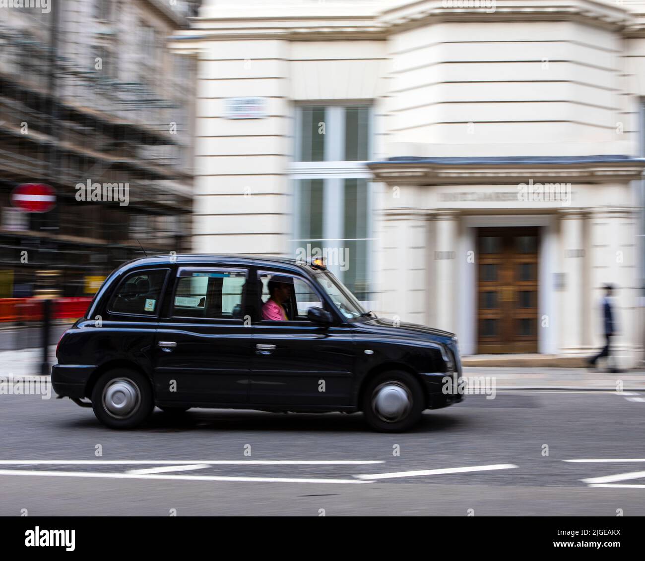 London, UK - August 12th 2021: A panning shot of a London Taxi, also ...