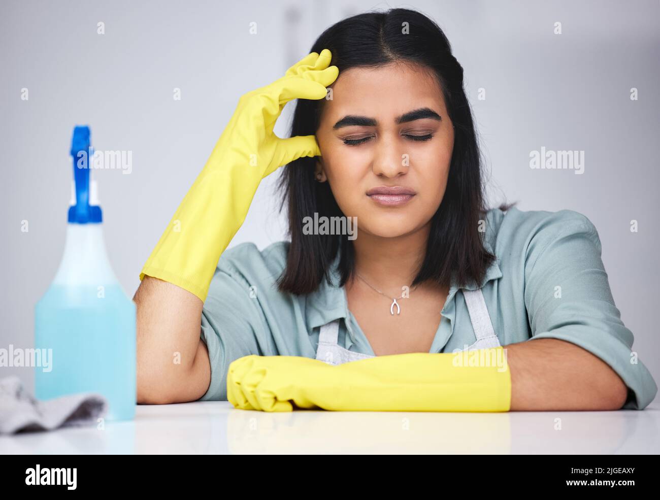 I can understand why people hate housework. a young woman looking bored ...