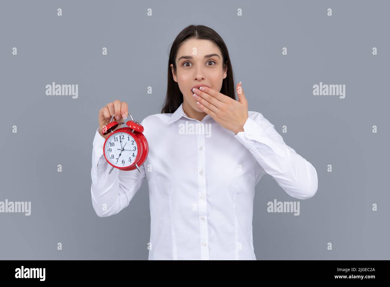 Photo of shocked girl hold alarm clock, crazy girl isolated gray ...