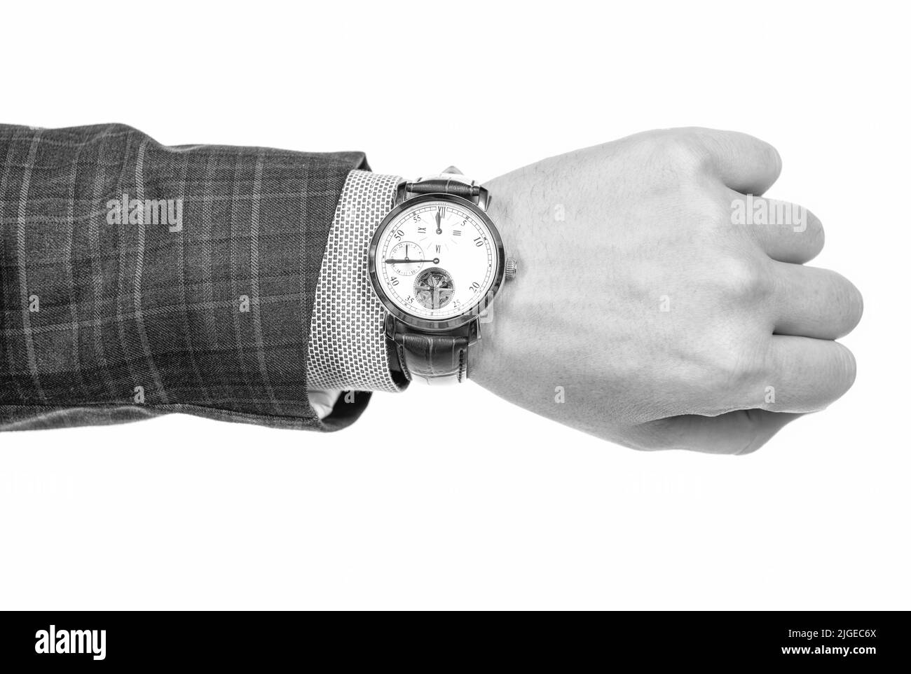 Analog wrist watch worn on male hand in business suit isolated on white ...