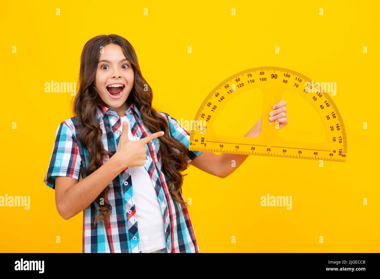 Amazed teen girl. School girl holding measure for geometry lesson ...