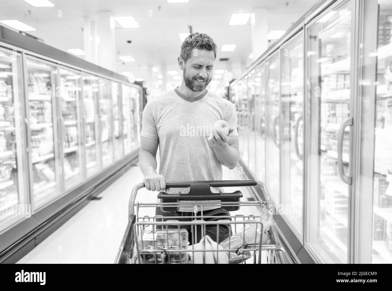 happy man with shopping cart hold apple. customer consumer with ...
