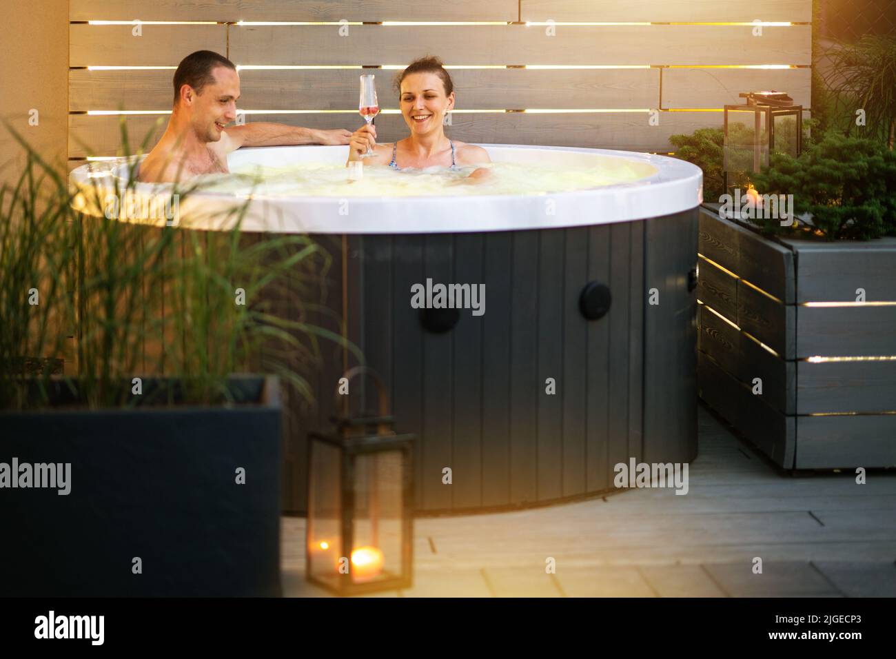 Caucasian Couple Having Fun and Lazy Time Inside a Garden Hot Tub ...