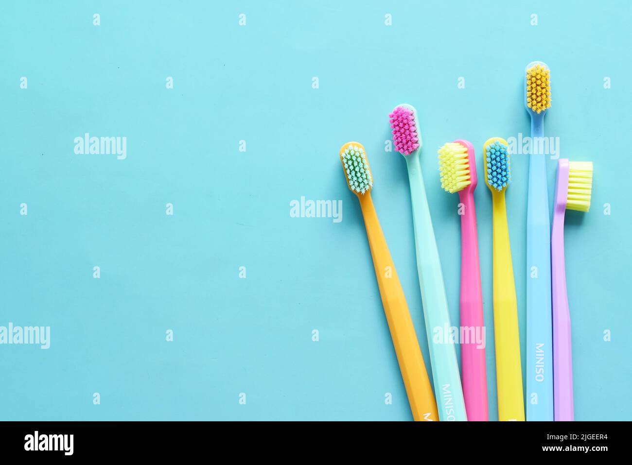 top view of colorful toothbrushes on light color background Stock Photo ...