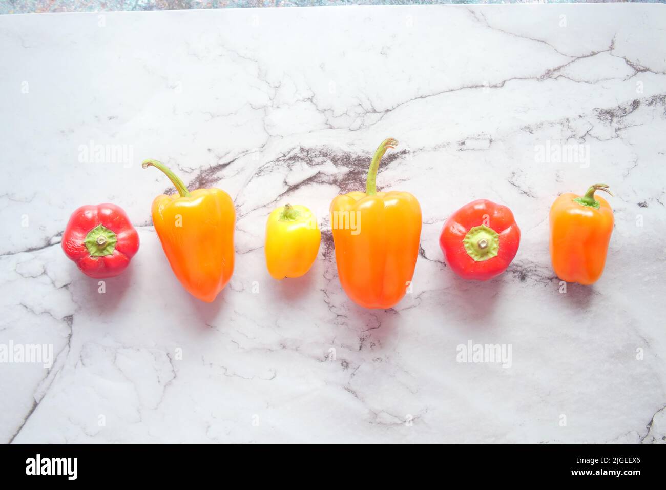 Yellow orange and red capsicum on white background Stock Photo - Alamy
