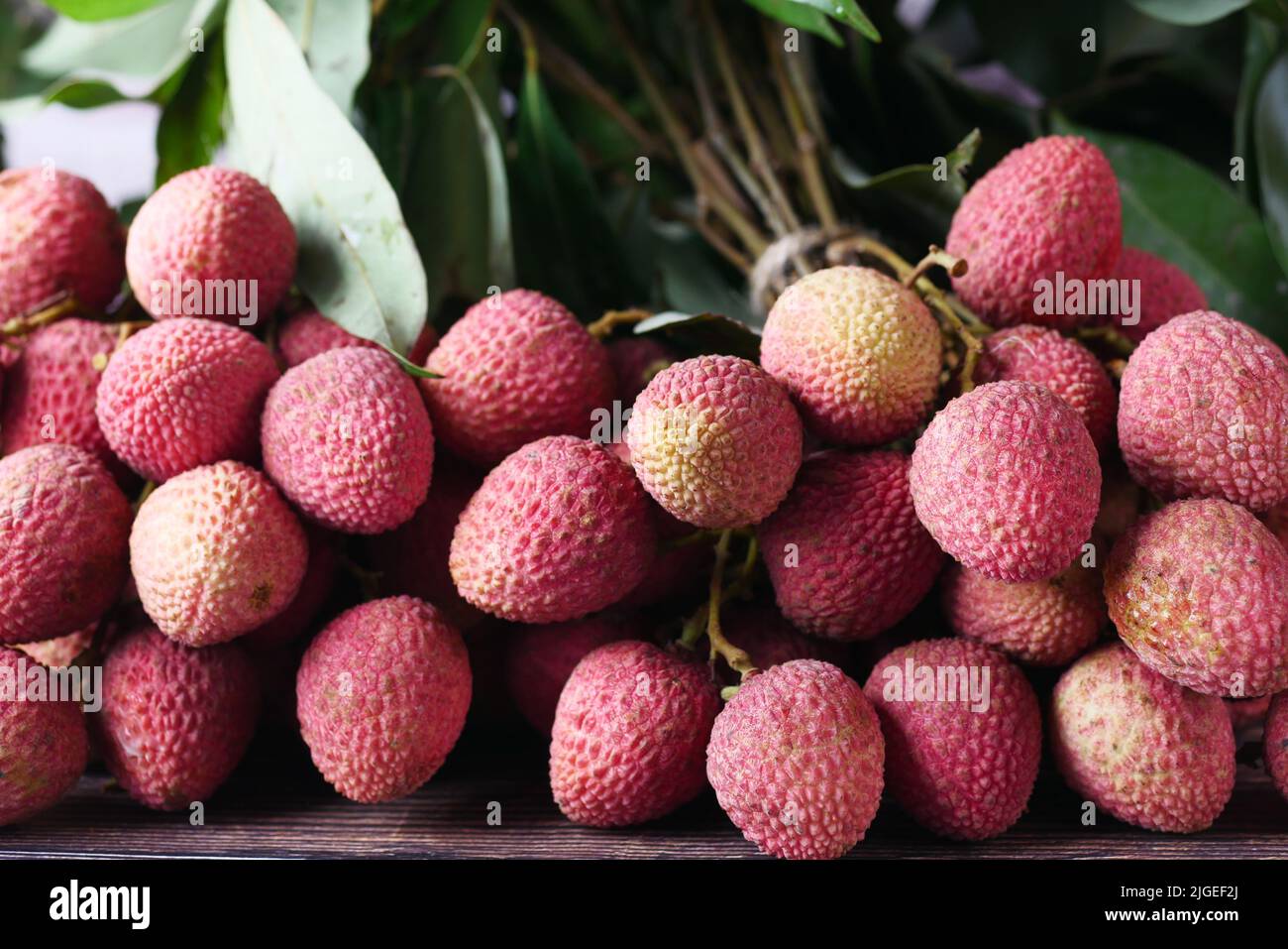 Lychee on a pink background top down Stock Photo - Alamy