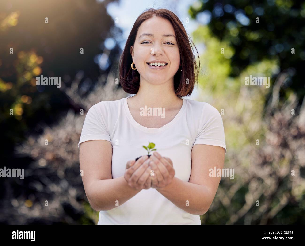 A good samaritan is a green samaritan. a young woman holding a plant ...