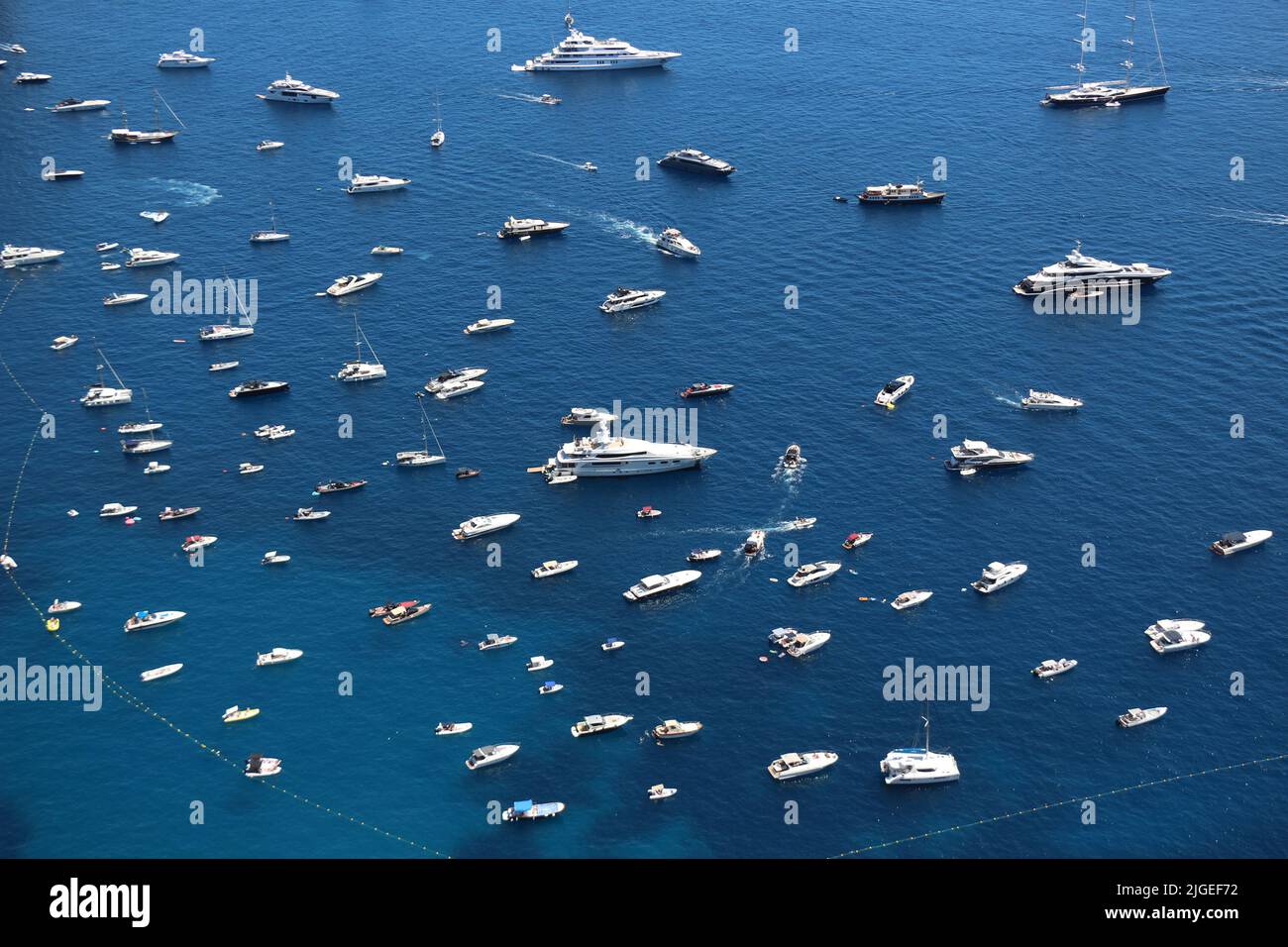 Summer in Capri island (Italy): Faraglioni, boats and yacht Stock Photo ...