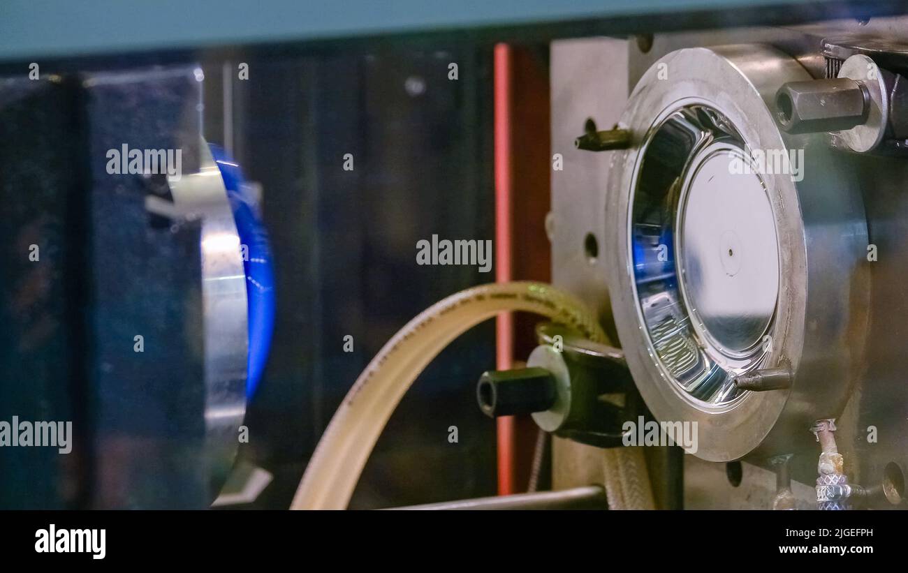 Close-up working metal industrial injection molding making machine ...