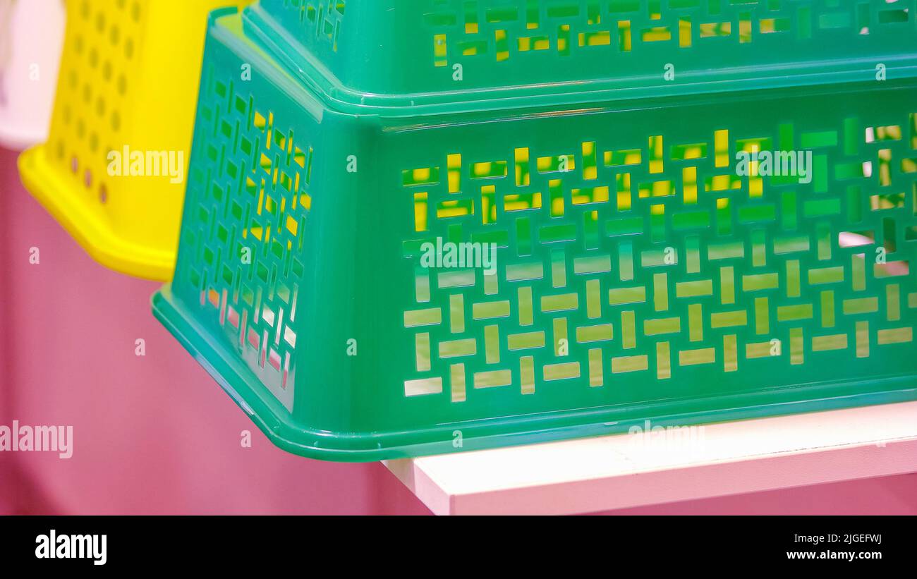Stack of colorful containers. Green and yellow plastic baskets Stock ...