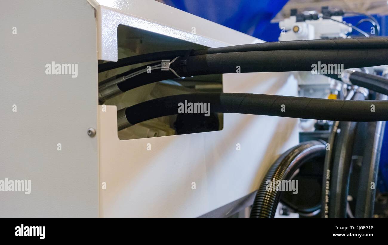 Close-up large black cables on the manufacturing machine. Electrical ...