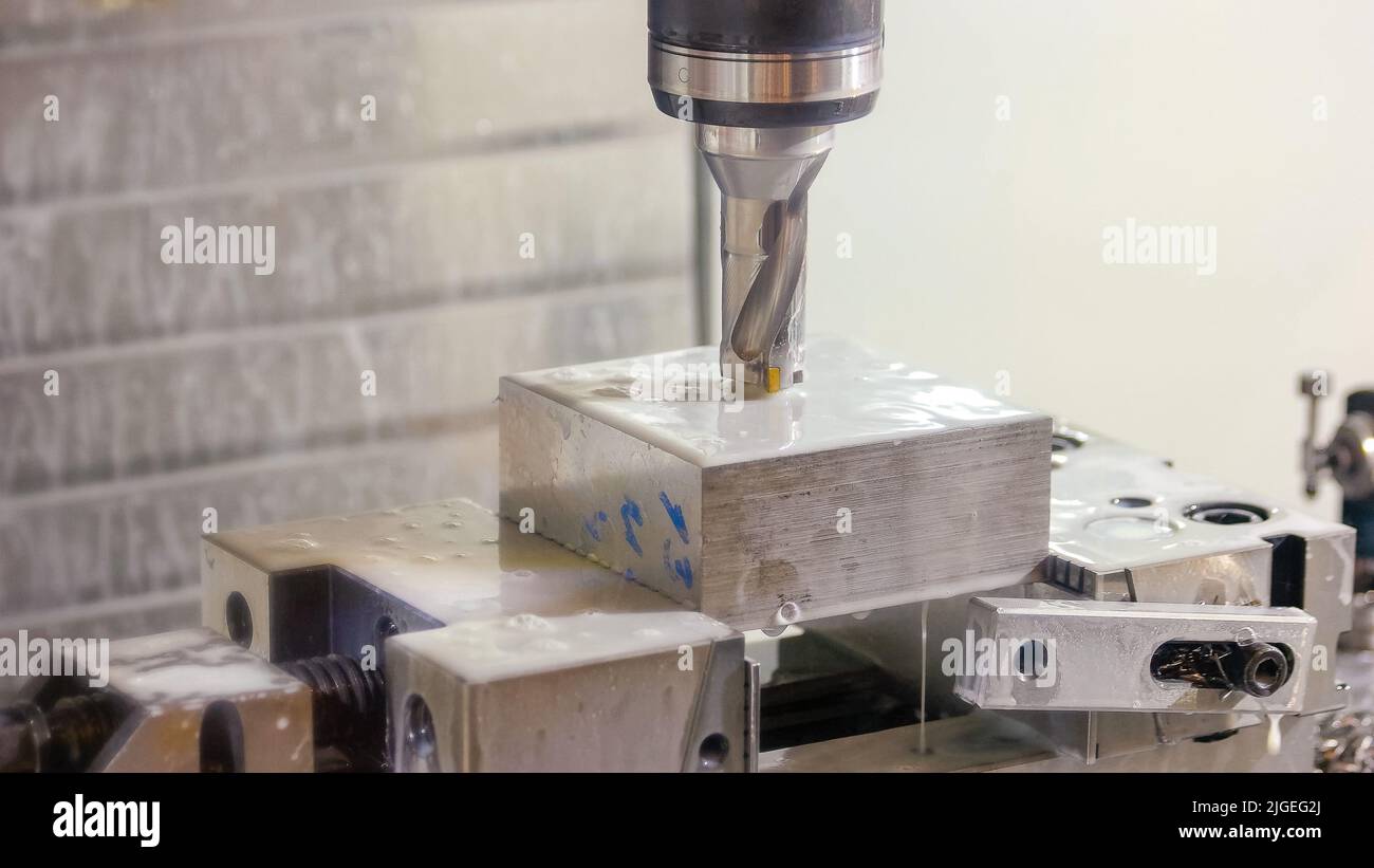 Washing a cut metal cnc drilling machine close-up. Water flow on the ...