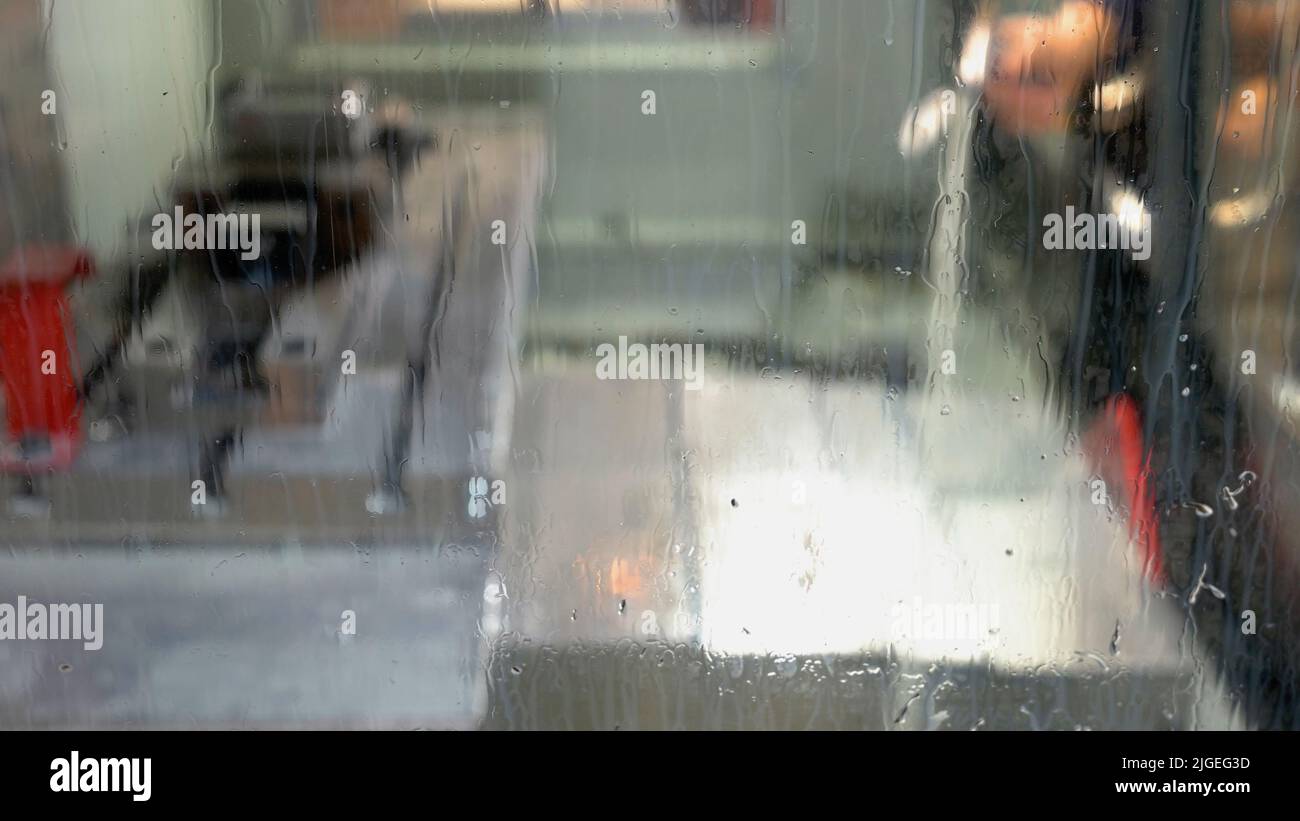 Worker is washing plant mill machine using a metal water sprayer. View ...
