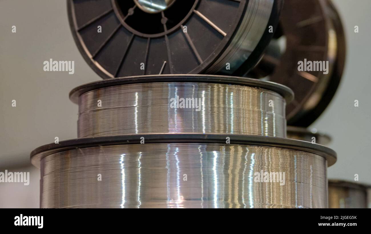 Close-up pile of larhe industrial steel coils. Stack of bobbins with ...