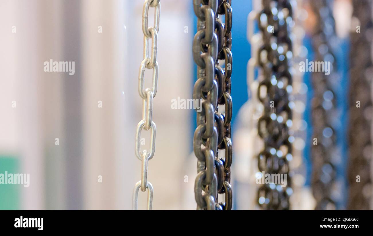 Close-up of various hanging strong metal chains. Chains of different ...