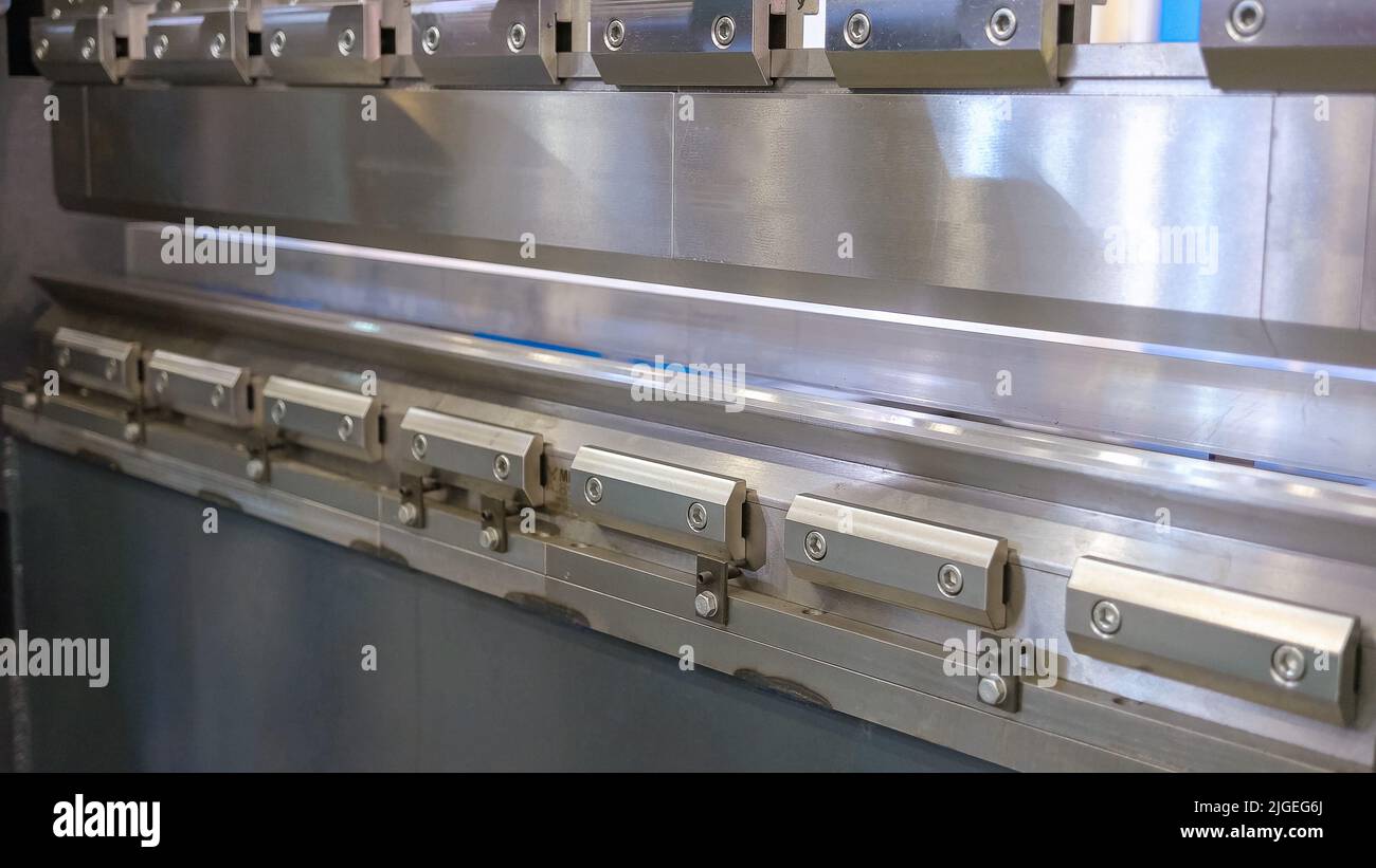 Close-up opening of large stainless industrial machine. Motion of a big ...