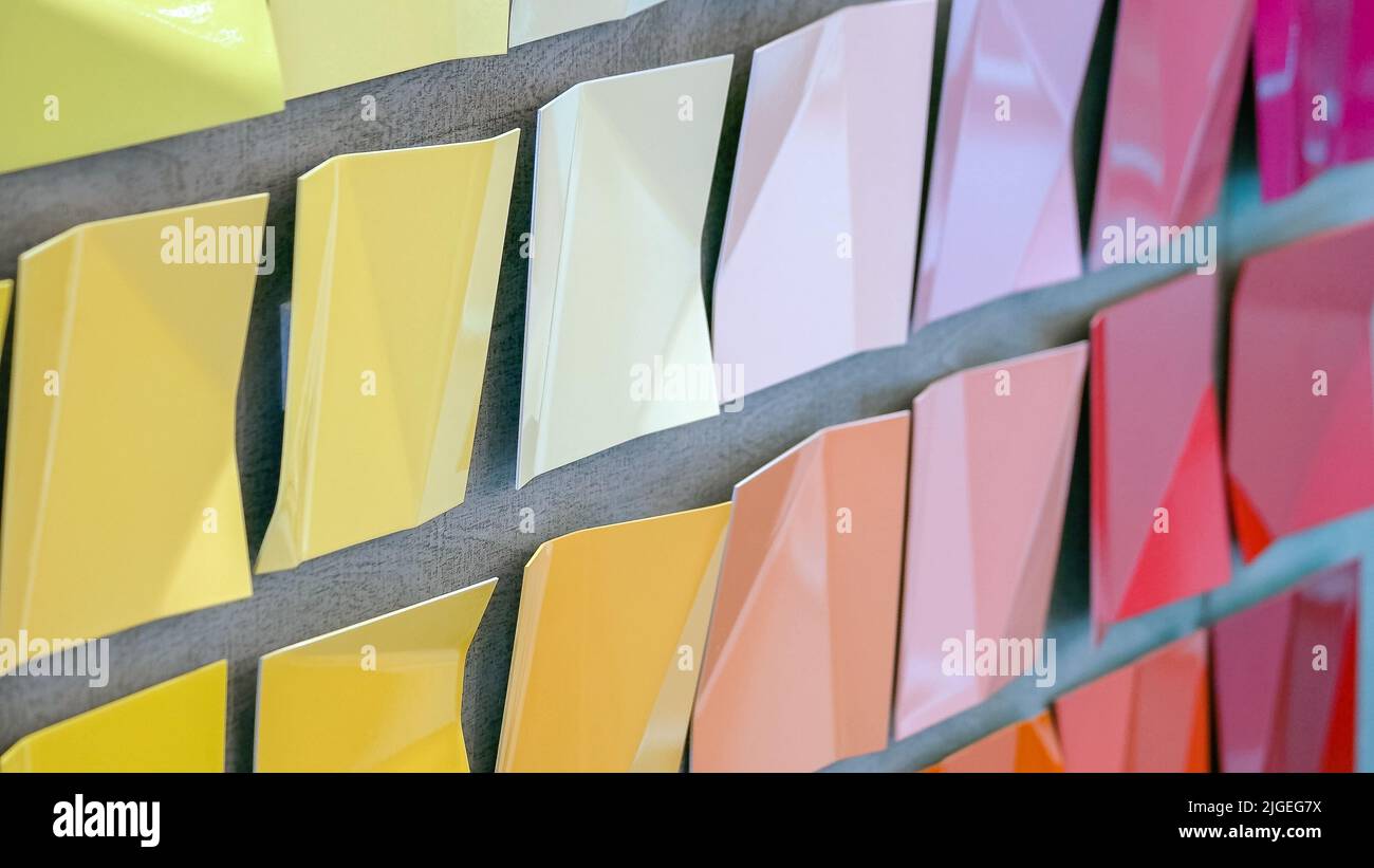 Many hanging colored metal square plates of different color. Colorful ...