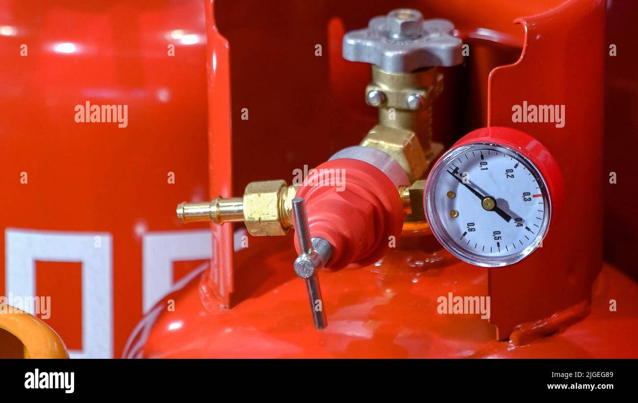 Close-up of large red ballong with pressure indicator. Propane storage ...