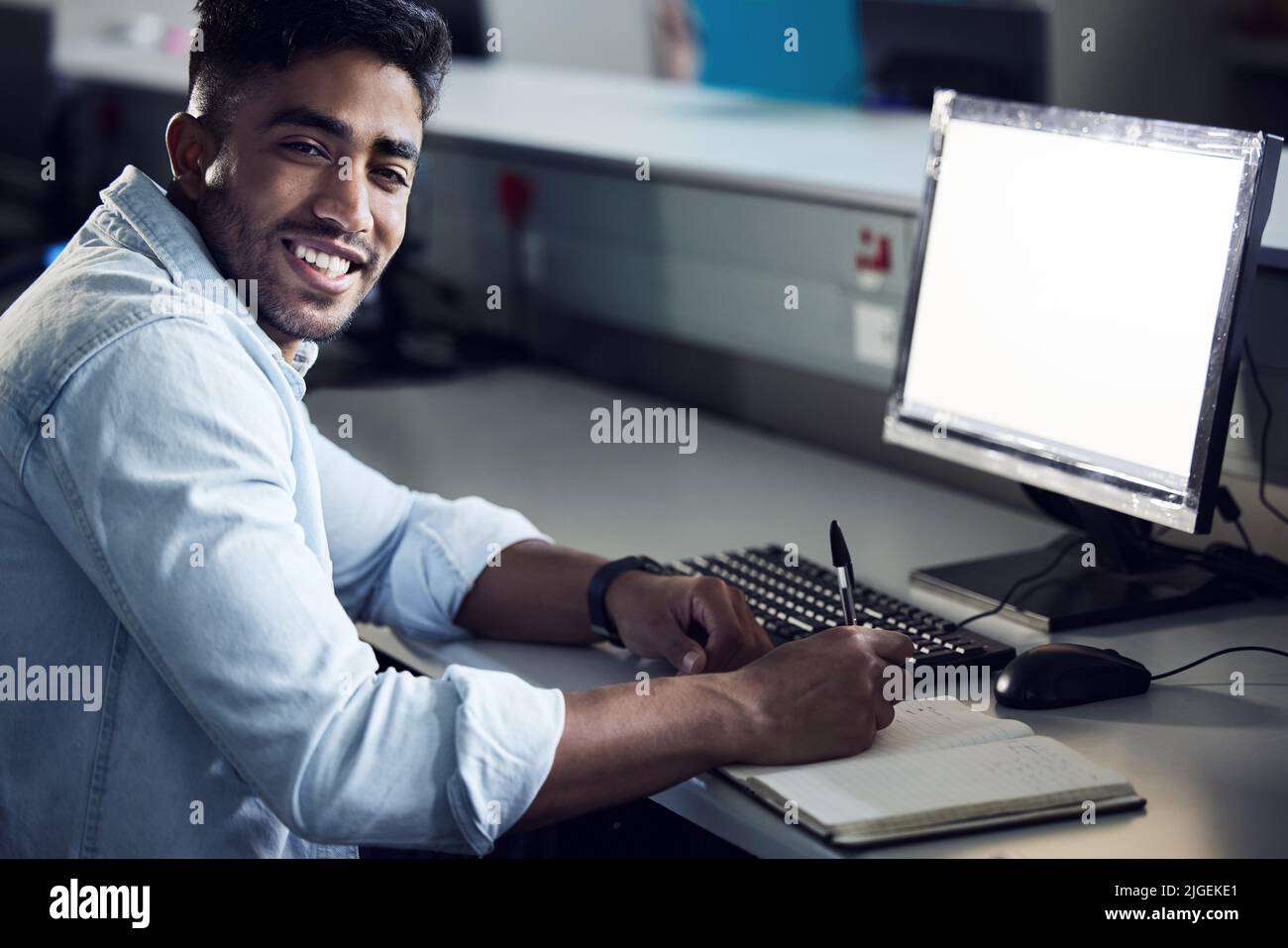 Where IT gurus get their degrees. a young man writing in a notebook and ...
