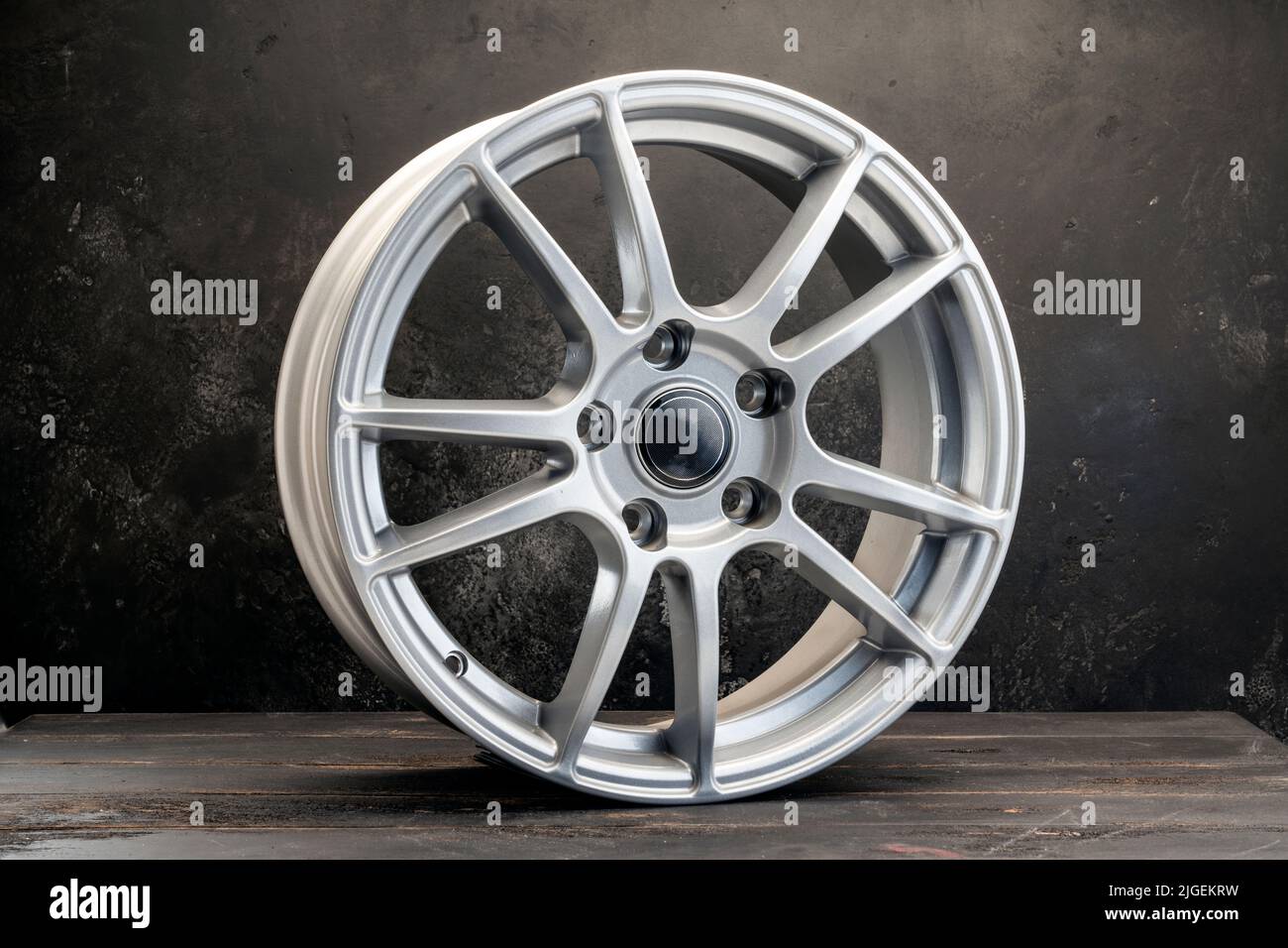 new grey alloy wheels on a dark textured black background. a wheel for ...