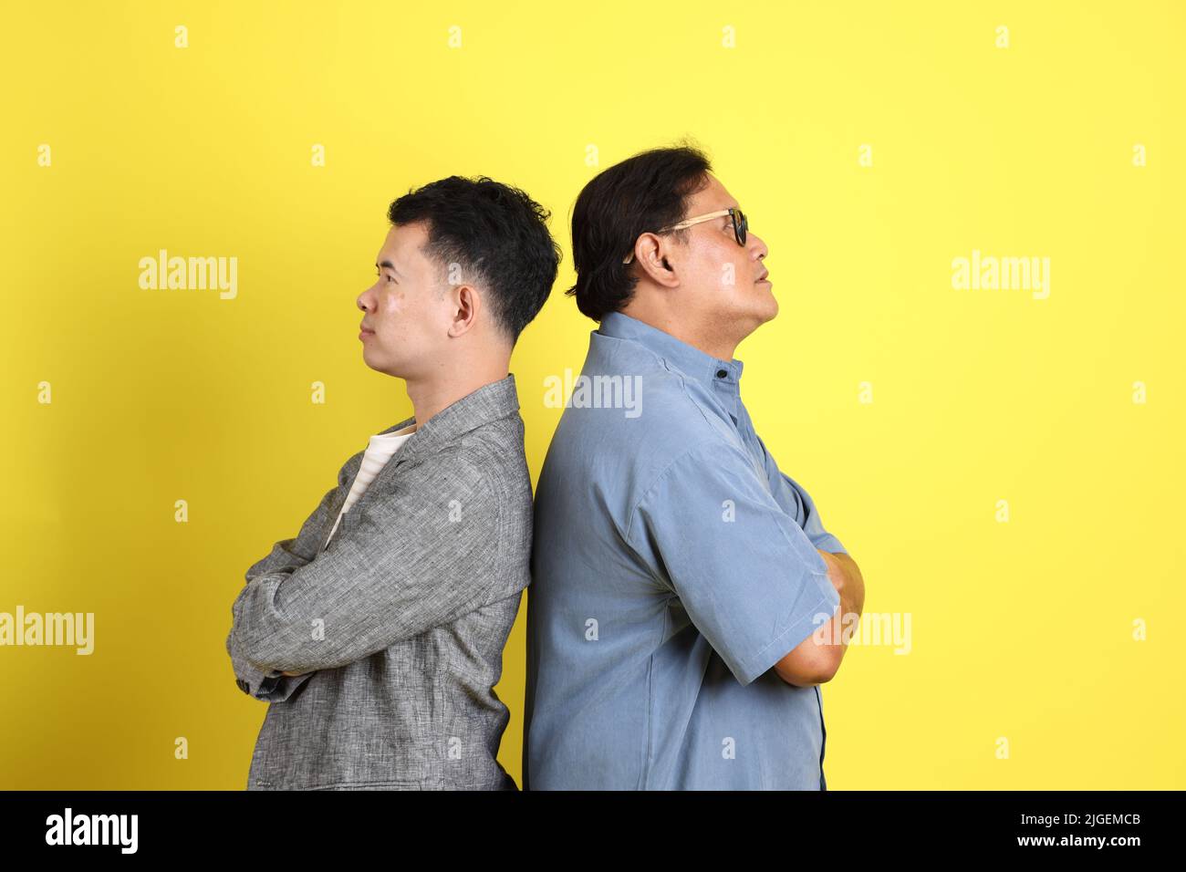 The adult two people standing on the yellow background Stock Photo - Alamy