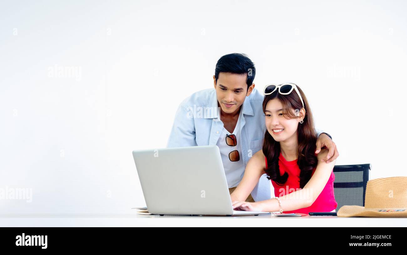 Happy Asian couple, young woman and man using laptop computer on desk ...