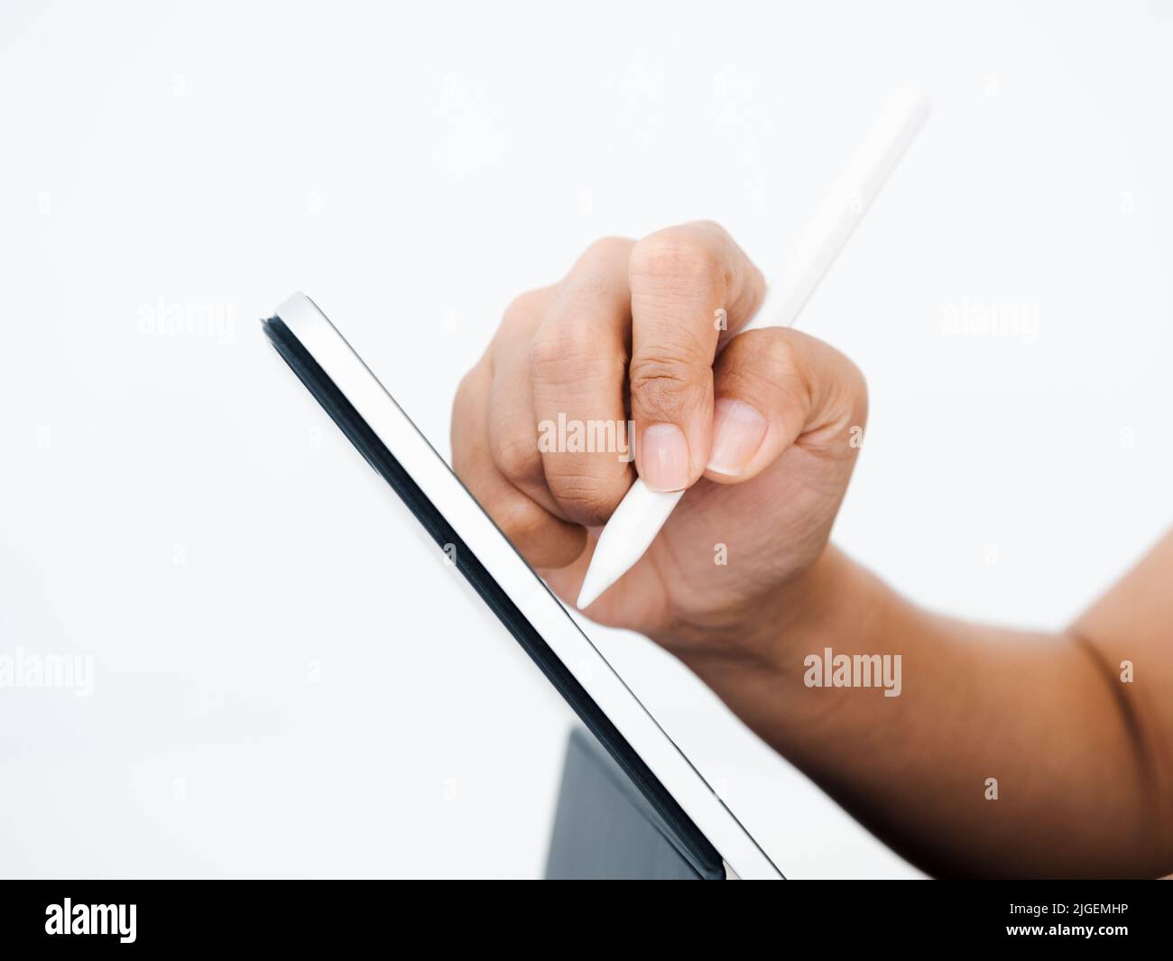 Close up hand holding and write, draw or sign on digital tablet screen ...