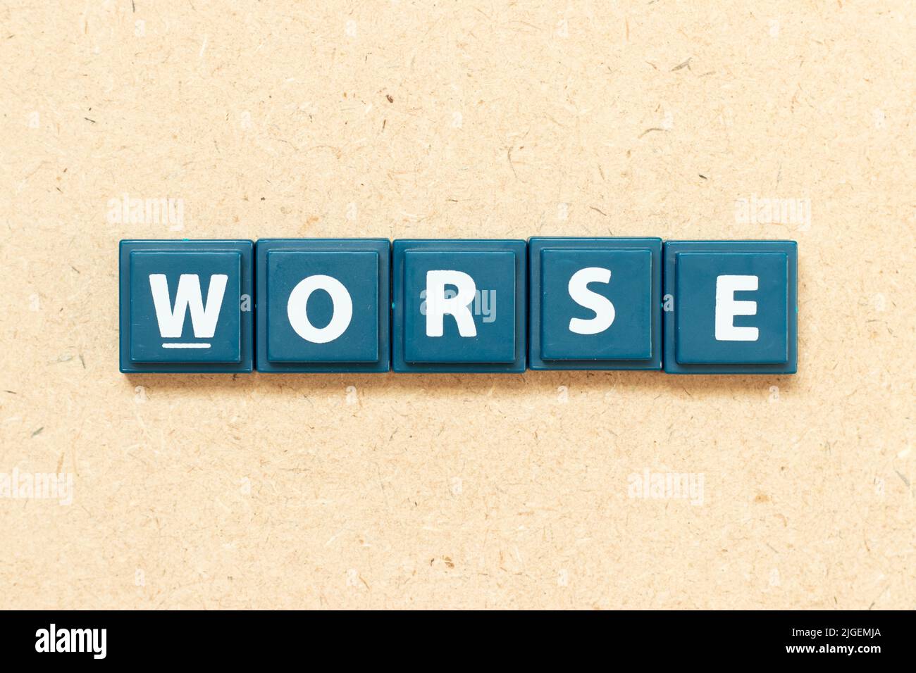 Tile alphabet letter in word worse on wood background Stock Photo - Alamy