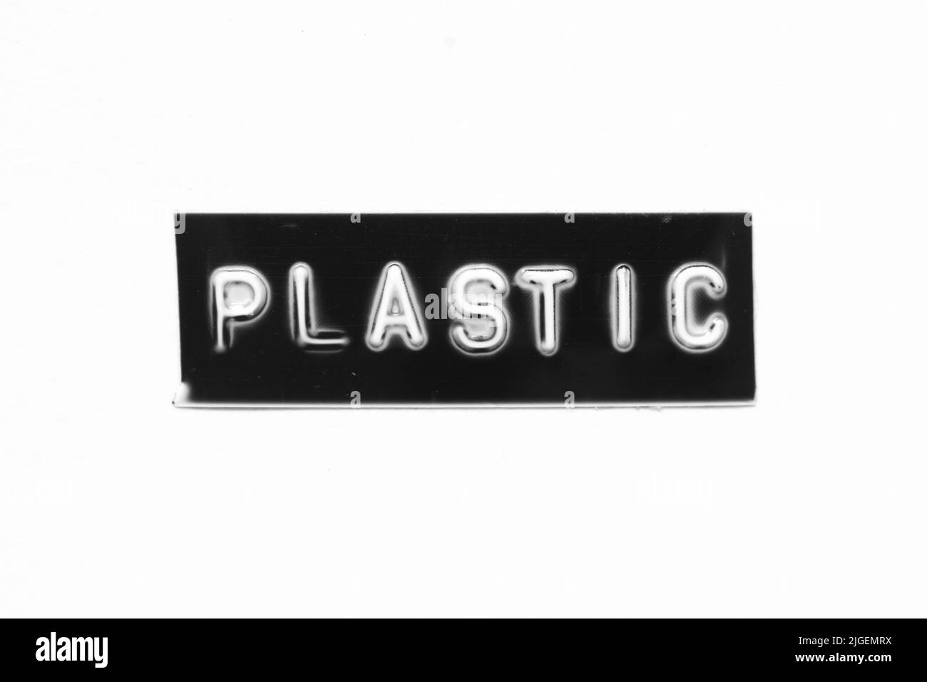 Black color banner that have embossed letter with word plastic on white ...